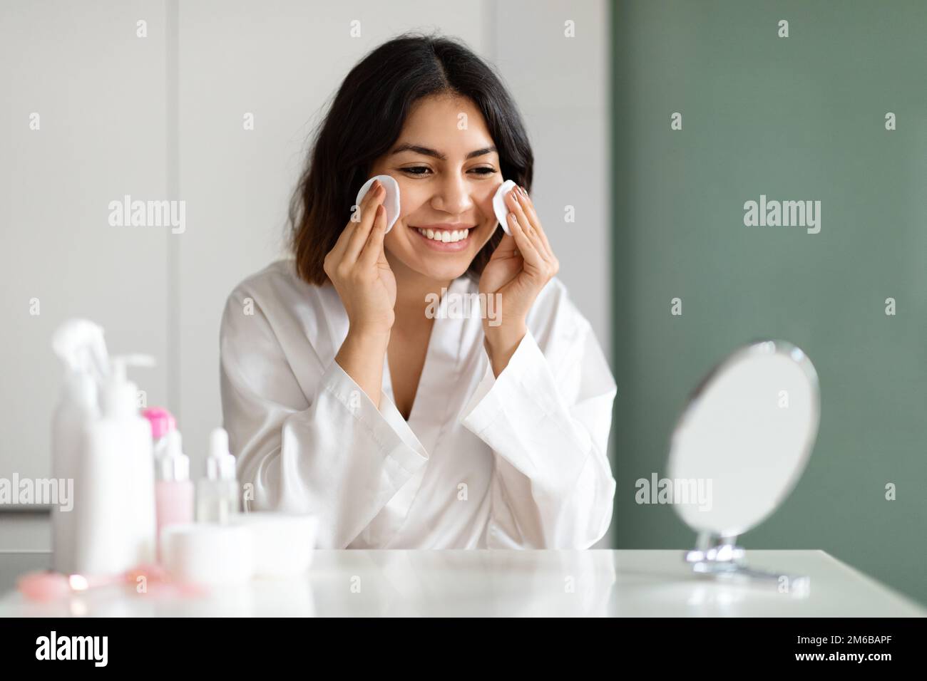 Pretty young lady using cotton pads, removing makeup before sleep Stock ...