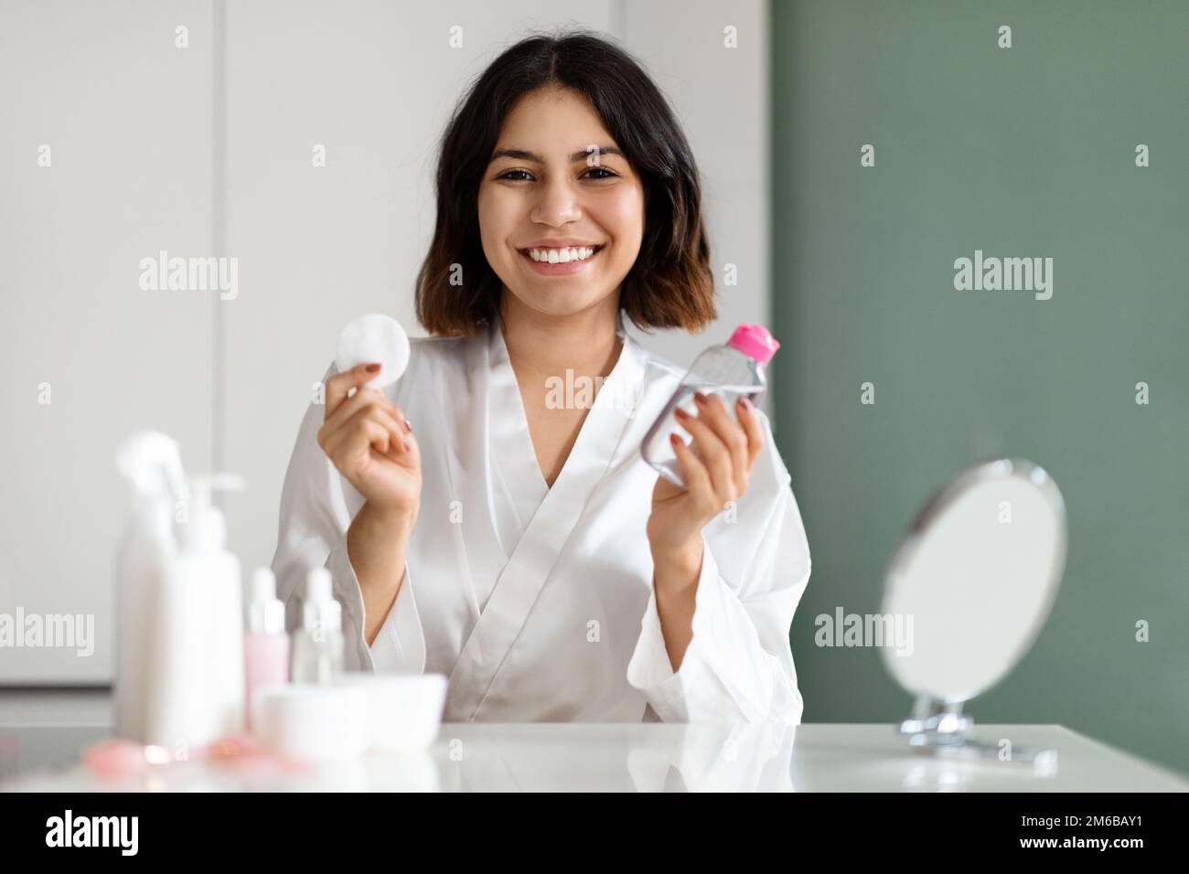 Lady using micellar water and cotton pad for makeup removal Stock Photo ...