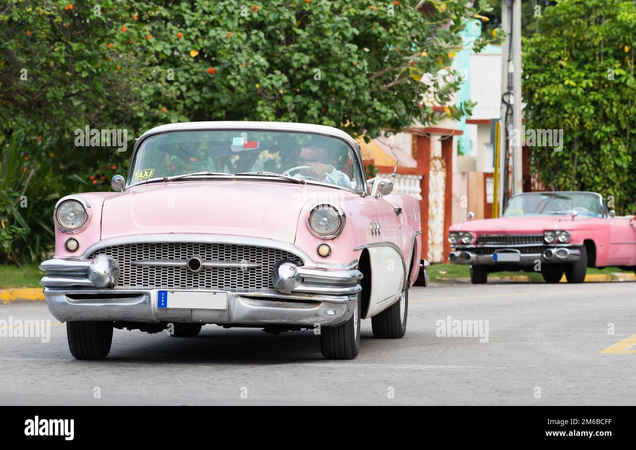 Pink vintage car driving in Cuba Varadero Stock Photo - Alamy