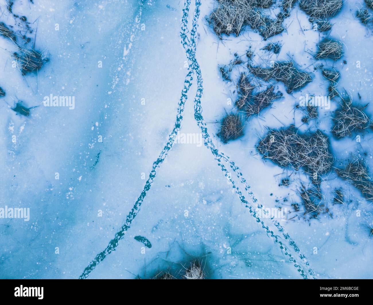 Panoramic aerial view of a frozen lake with animal footprints. Animal ...