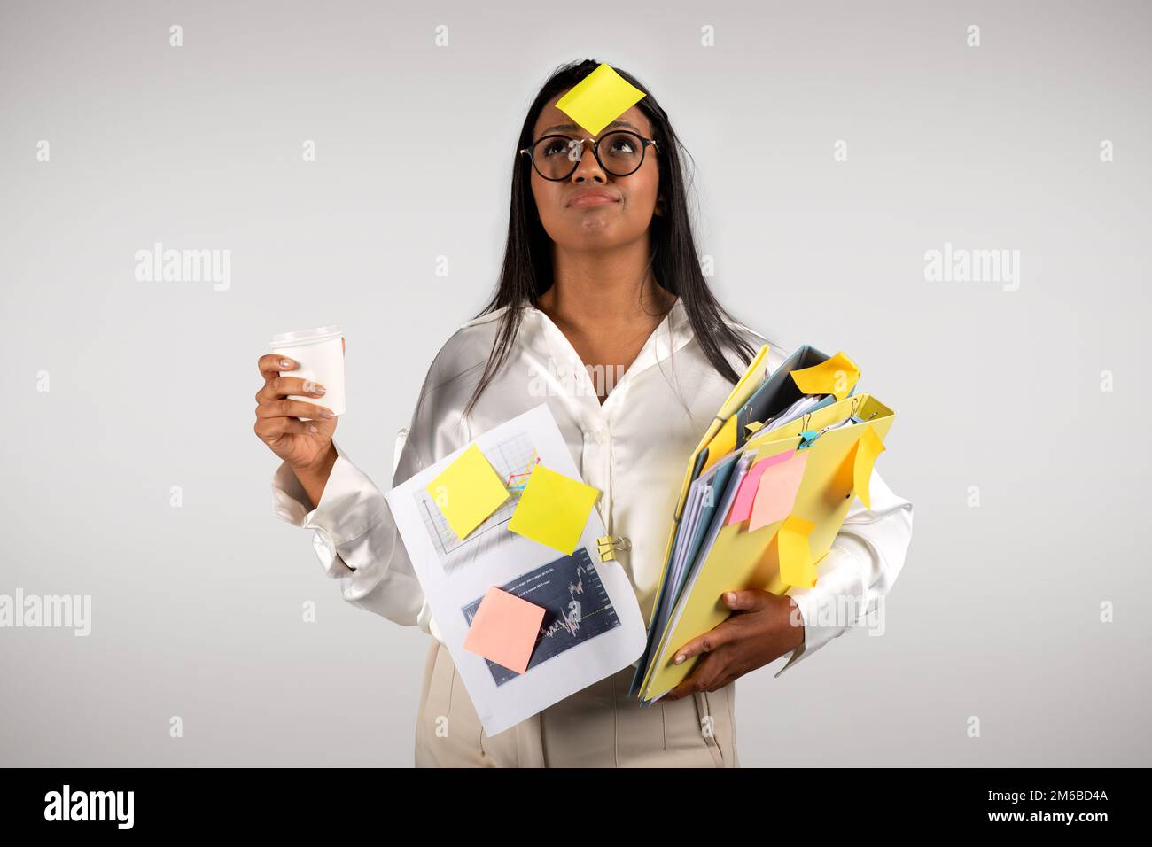 Busy tired young black business woman in glasses with many folders with ...