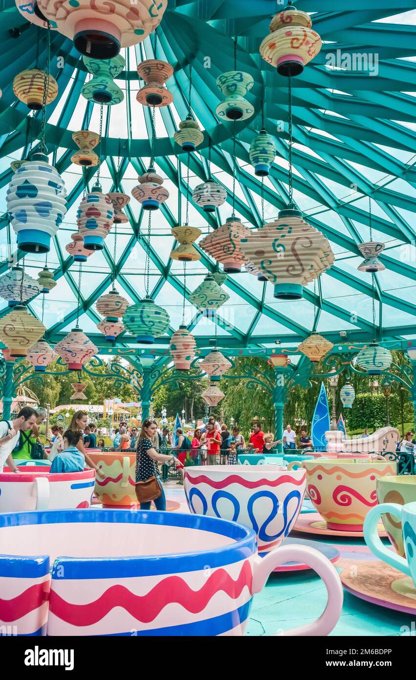 A beautiful shot of people enjoying the Mad Hatter's Tea Cups' carousel ...