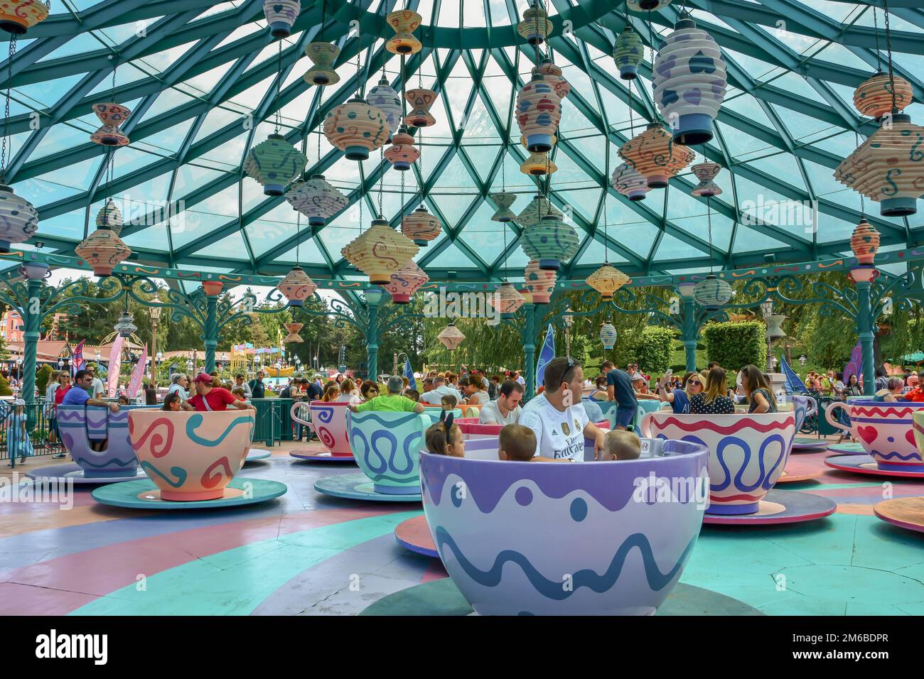 A beautiful shot of people enjoying the Mad Hatter's Tea Cups' carousel ...
