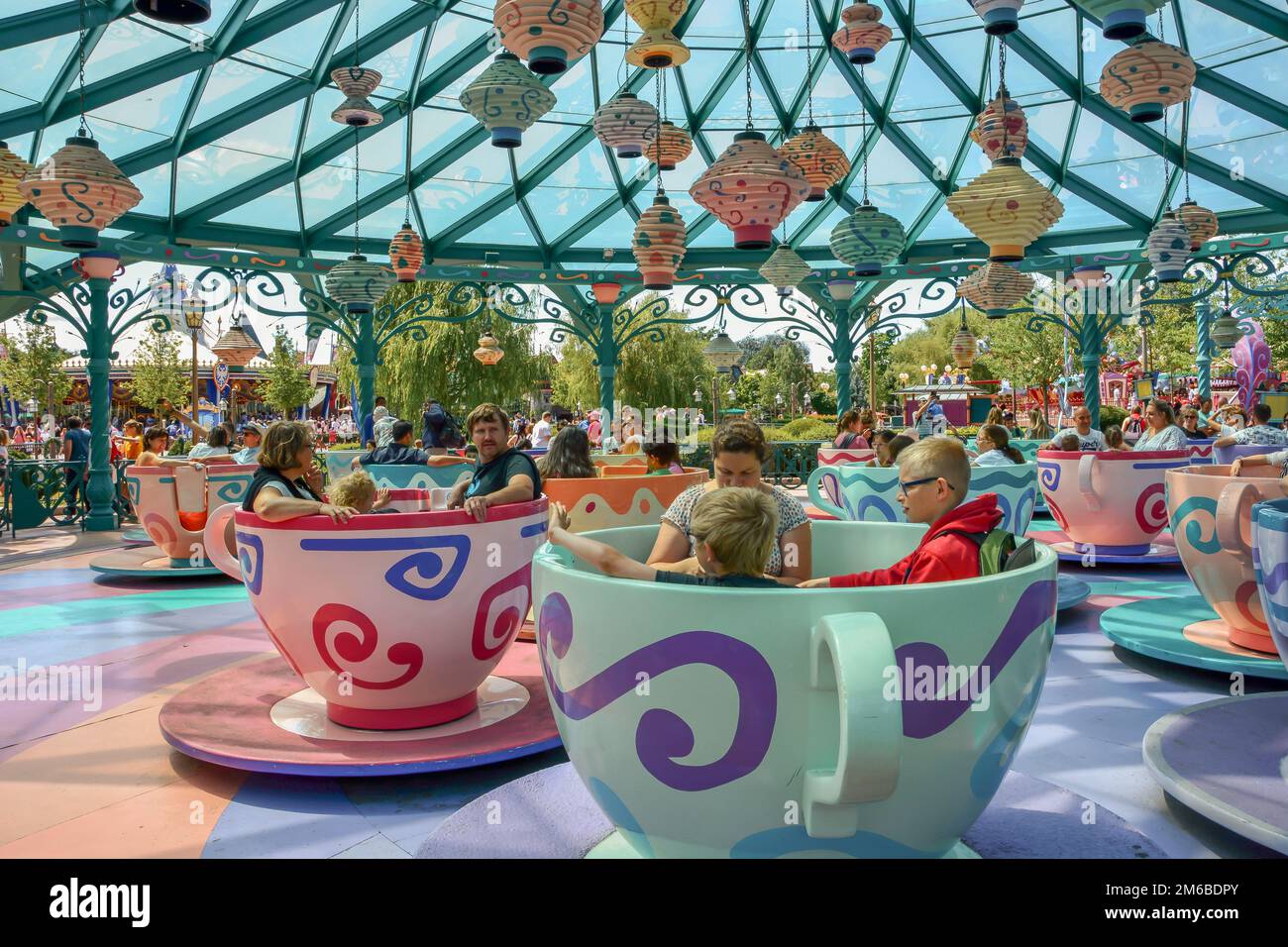 A beautiful shot of people enjoying the Mad Hatter's Tea Cups' carousel ...