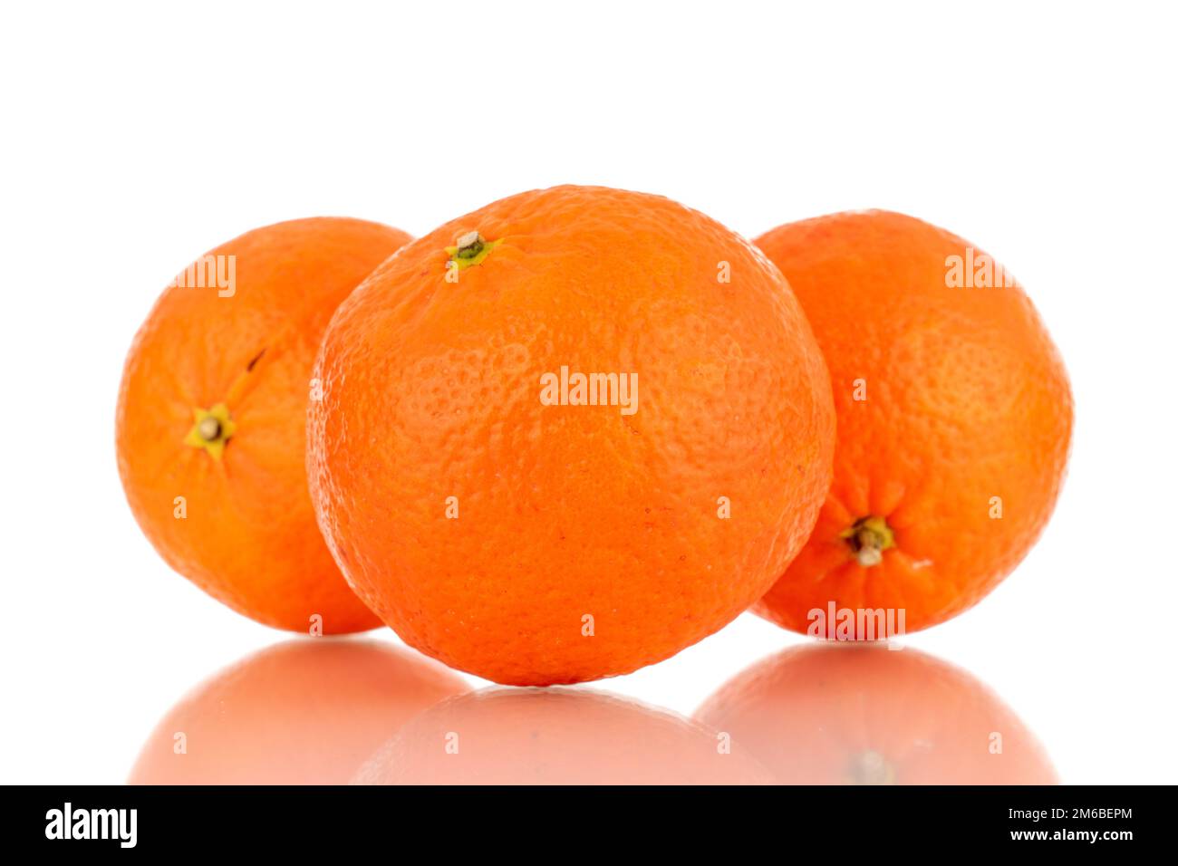 Three sweet organic tangerines, macro, isolated on white background ...