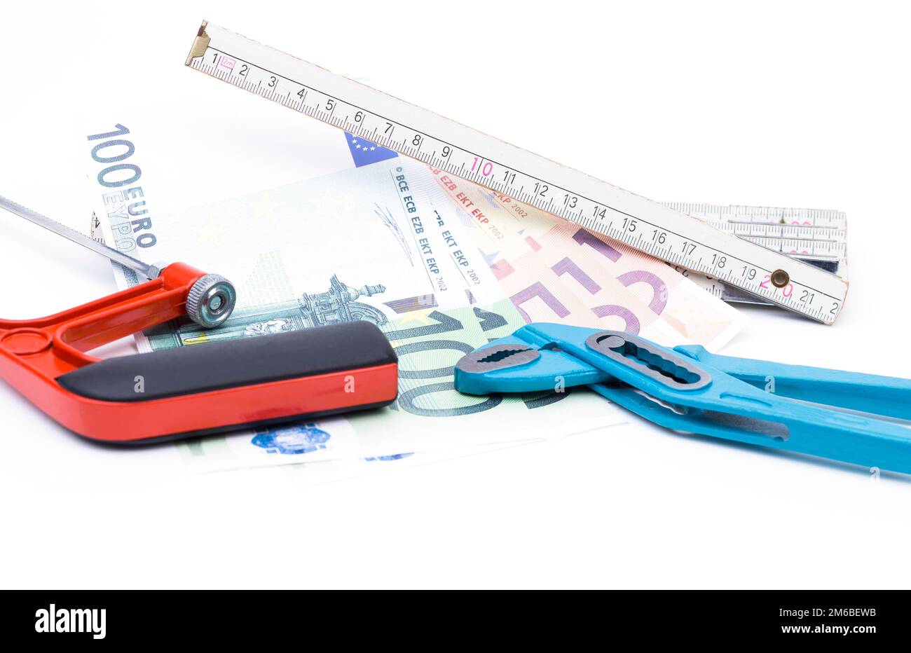 Folding rule with money and tools Stock Photo - Alamy