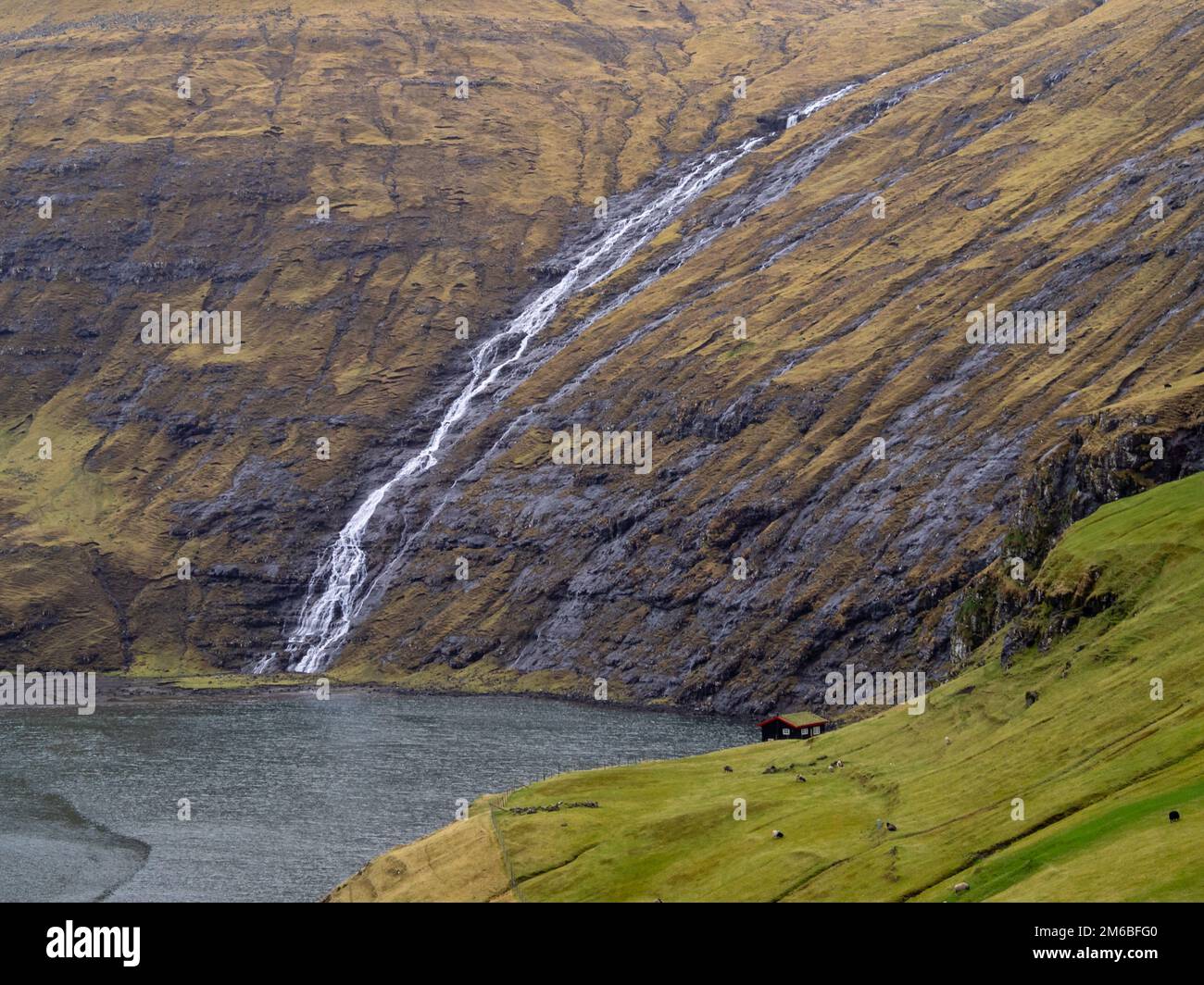 Saksun lagoon landscape with turf roofed house and waterfall Stock ...