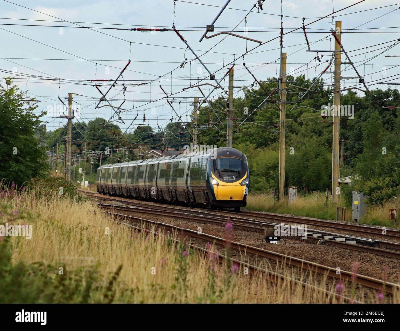 A Avanti West Coast Pendolino electric train hurries past Balshaw Lane junction on the West ...