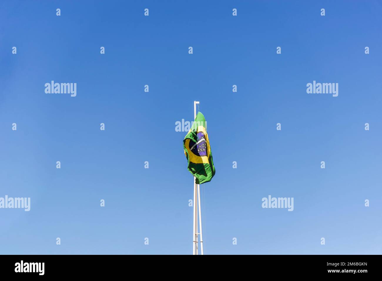 Flag of Brazil fluttering in the wind. In the center of the flag with ...