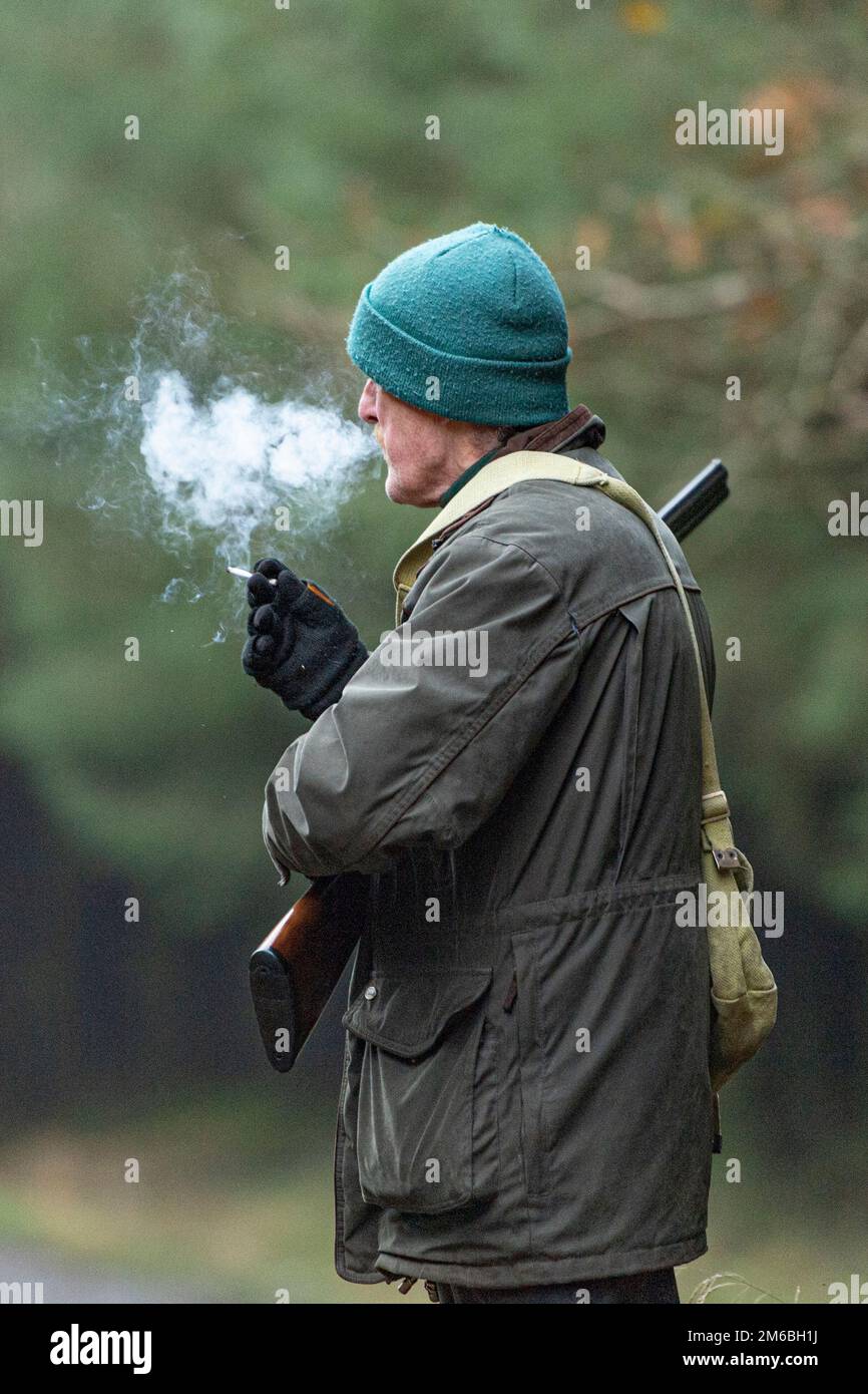 man smoking cigarette with shotgun Stock Photo - Alamy