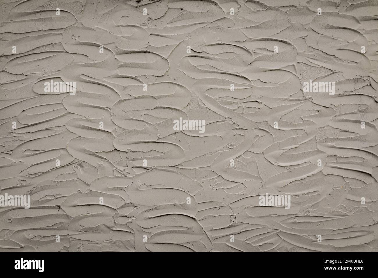 White wall or background of textured wavy stucco plaster material ...