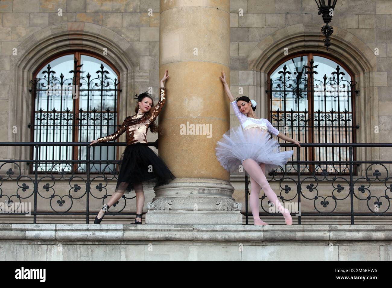 Two beautiful ballerinas dancing together around a column Stock Photo ...