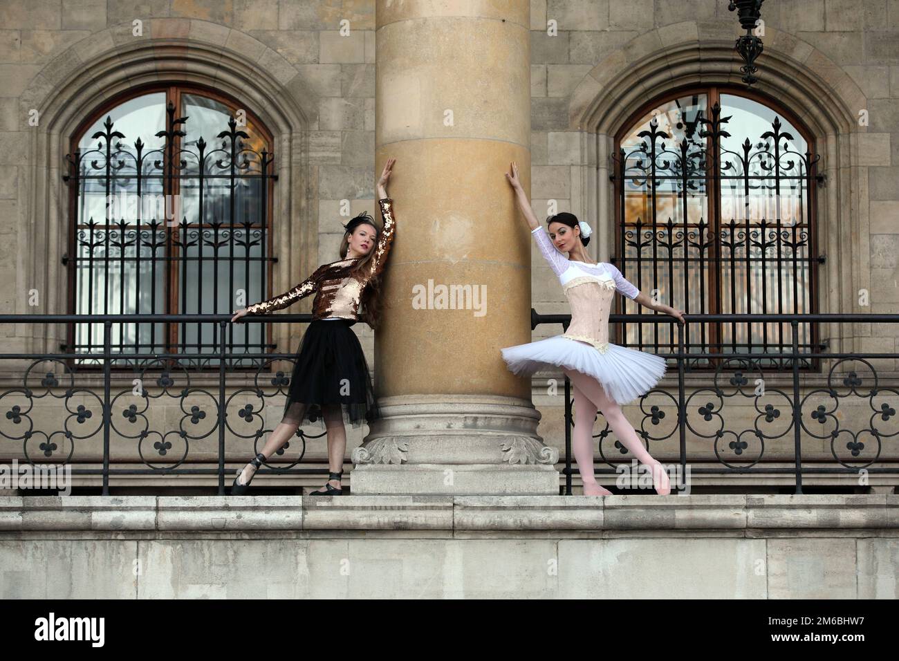 Two beautiful ballerinas dancing together around a column Stock Photo ...