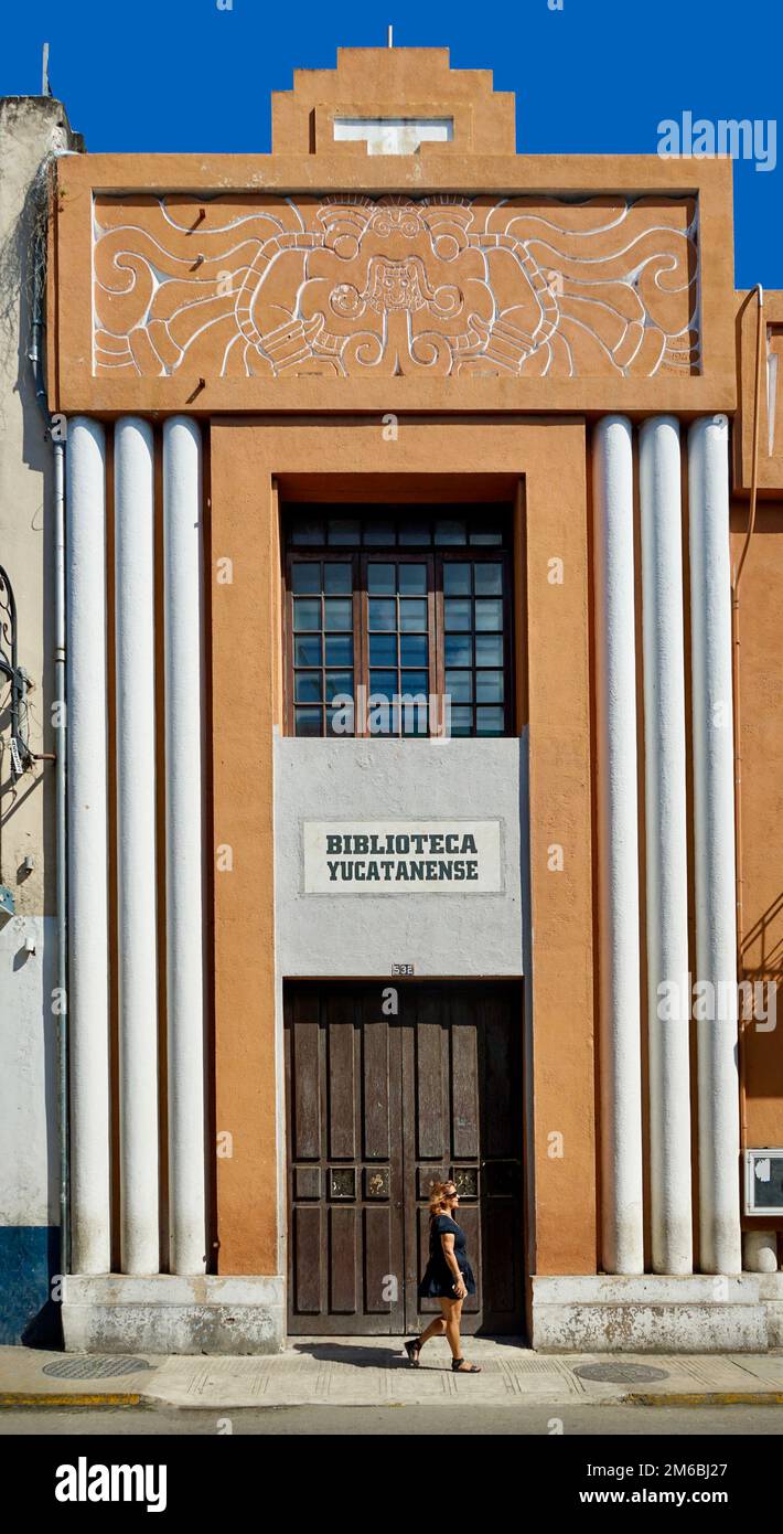 A woman walks past the striking Art Deco facade of the Yucatan Library ...
