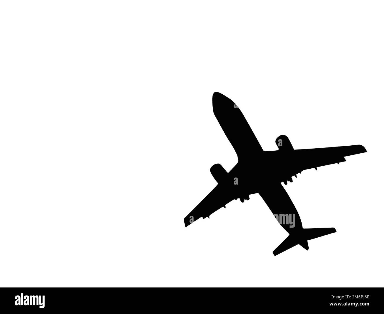 Silhouette of a passenger jet flying overhead on a plain white ...