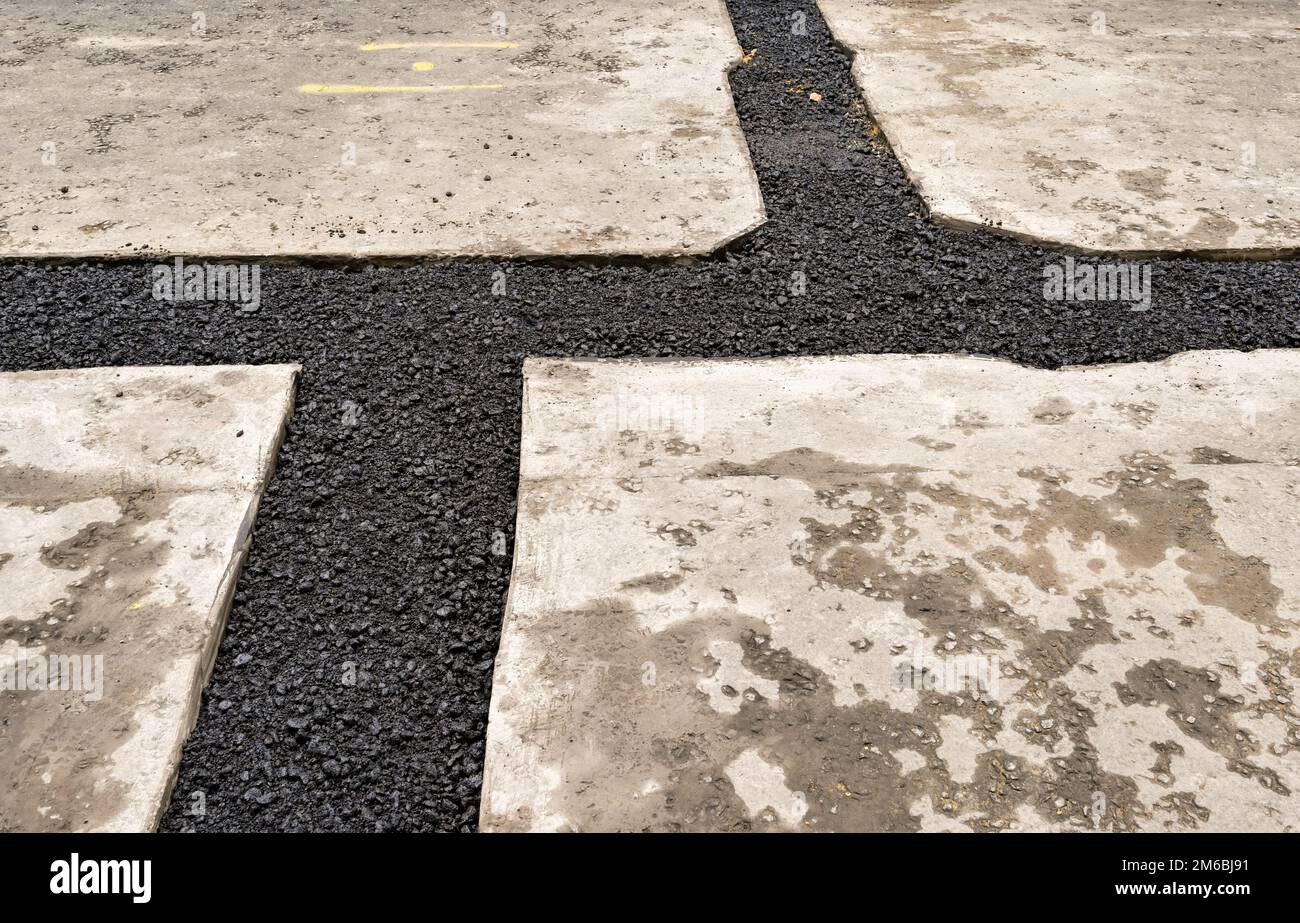 Tarmac laid on top of a trench dug on a city centre street. No people ...
