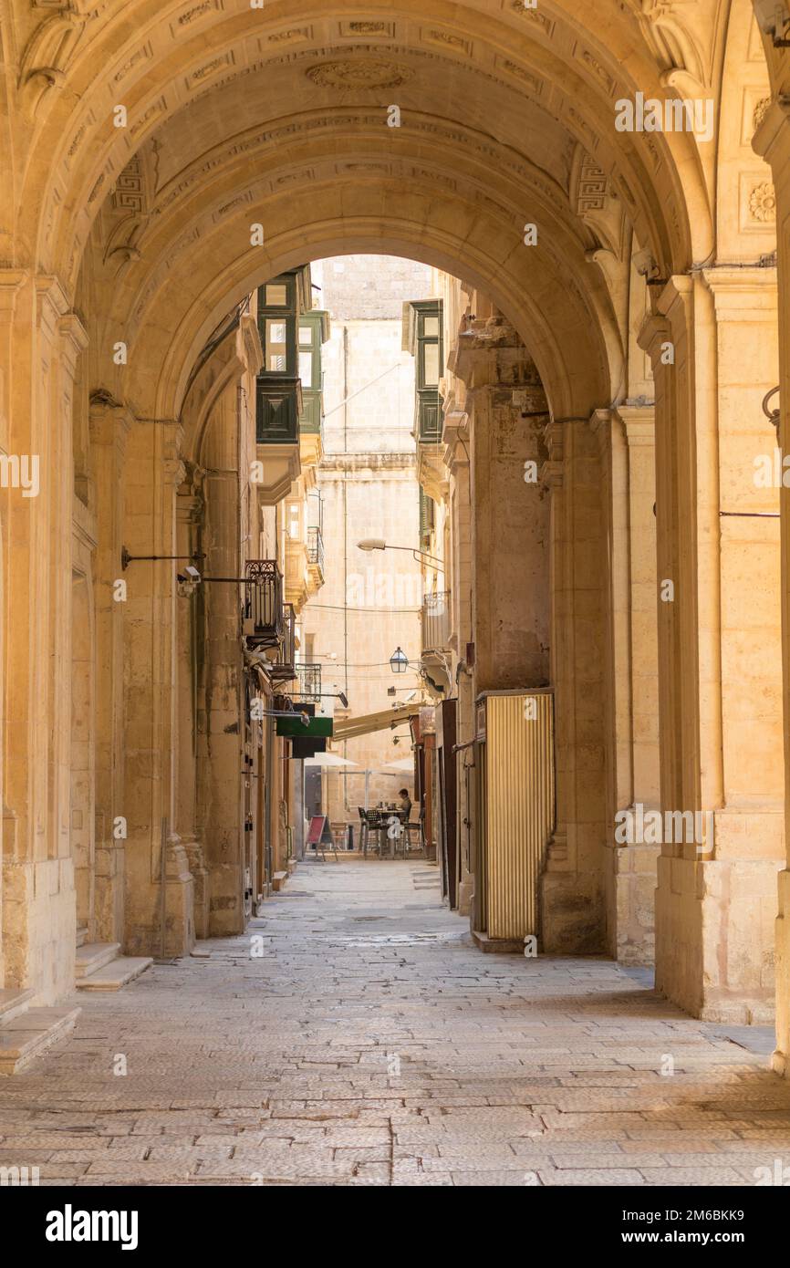 Maltese street in Valletta with beautifully carved golden limestone ...