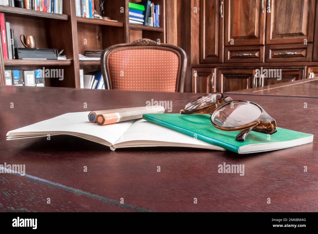 Set of Notebooks on Desk with Pencils and Glasses Stock Photo - Alamy