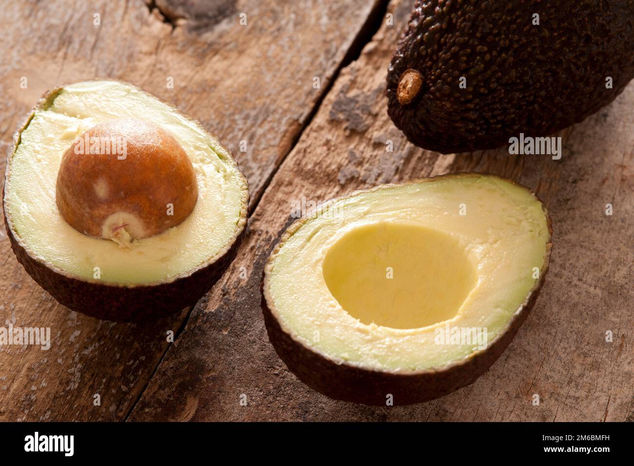 Delicious light green avocado sliced in half Stock Photo - Alamy