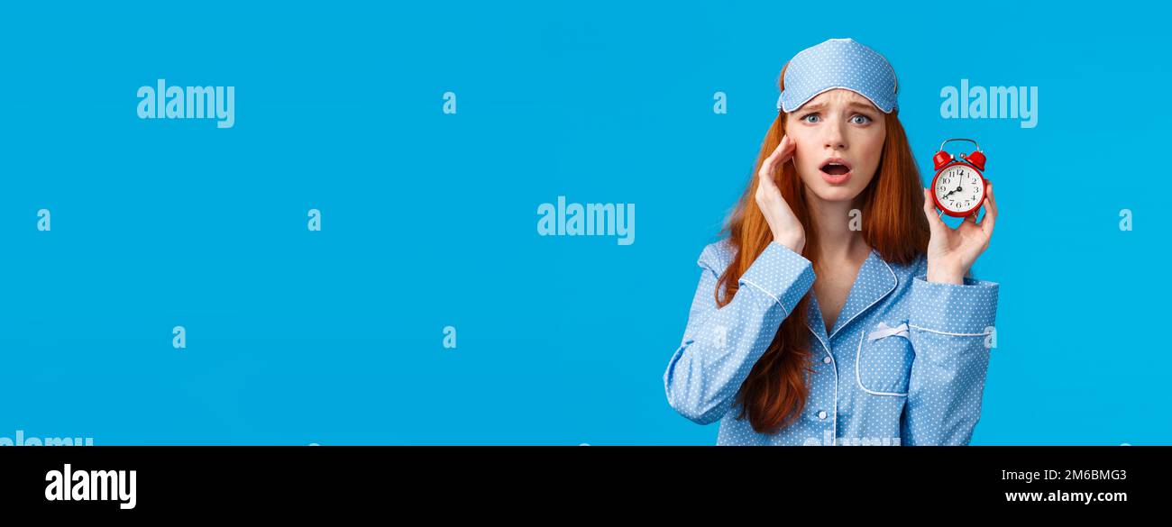 Upset and disappointed cute gloomy redhead girl overslept, forgot set ...