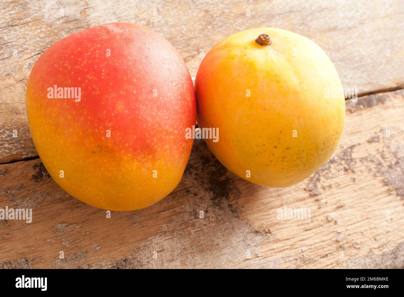 Two fresh whole sweet tropical mangoes Stock Photo - Alamy