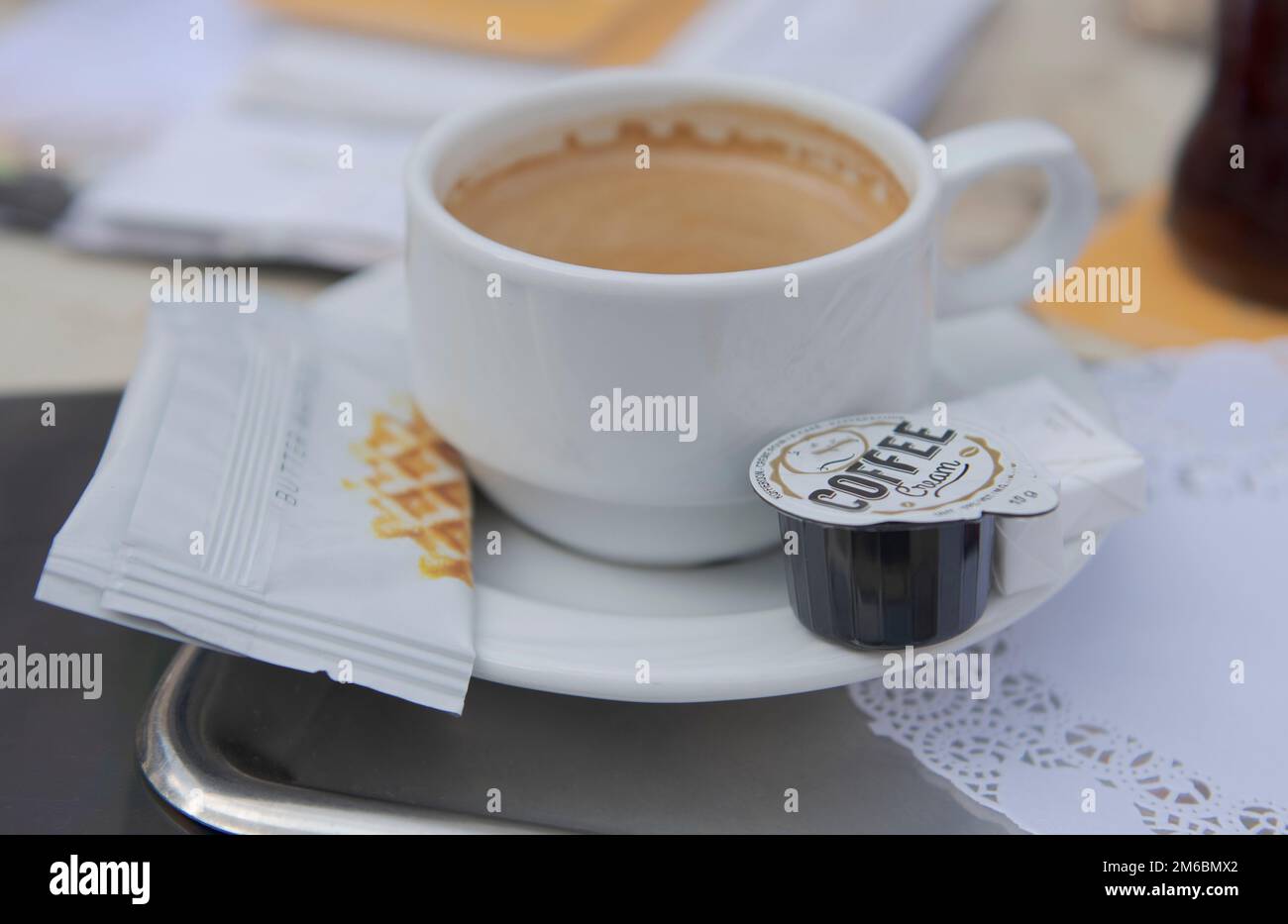 Cup of coffee in coffee with milk and waffle on a tray Stock Photo - Alamy