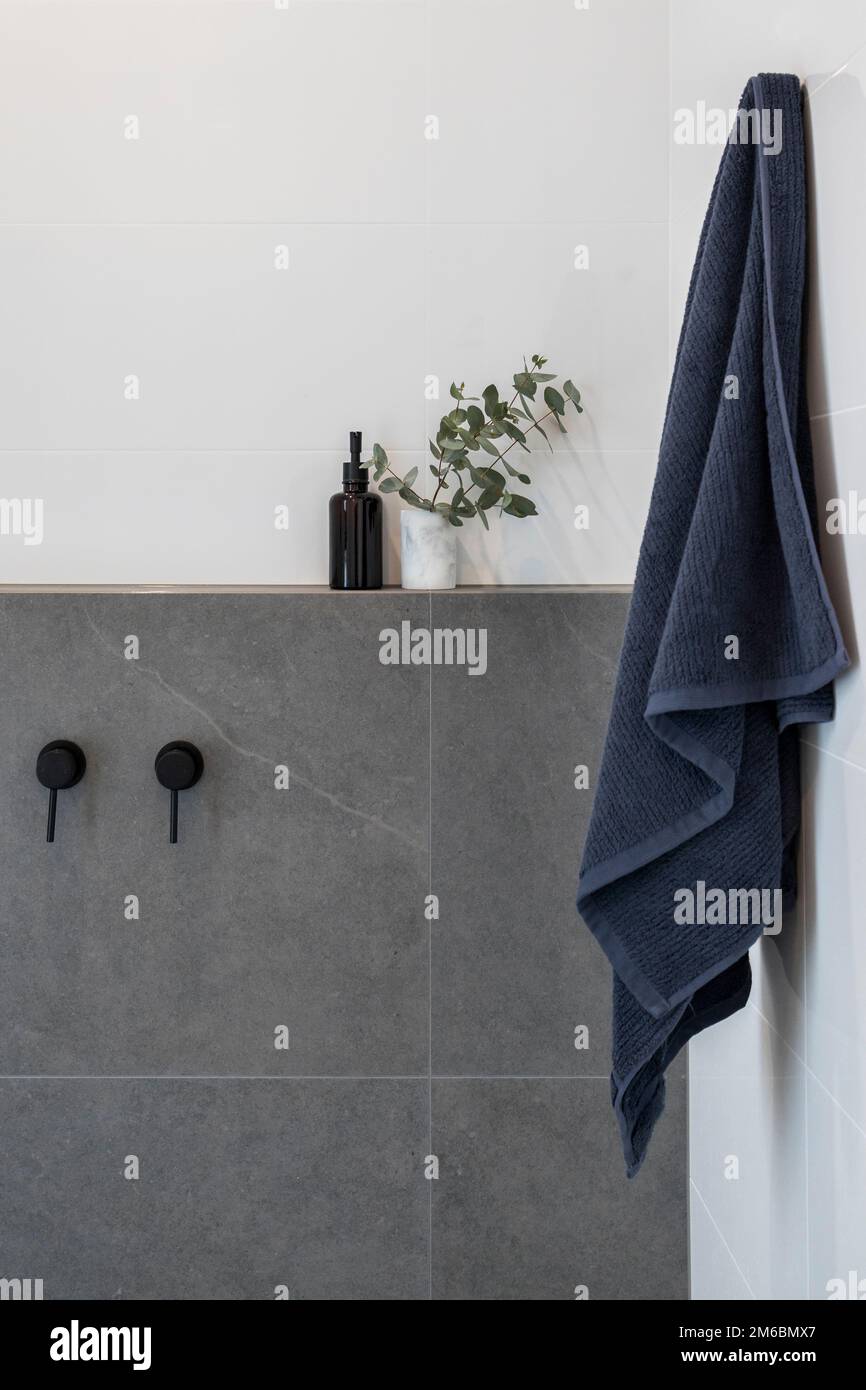 tiled bathroom shower area showing black hot and cold taps Stock Photo ...