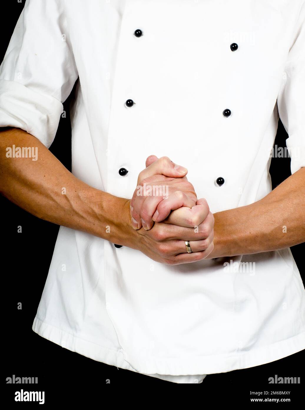 Professional chef with a hand gesture towards, wearing a chefs jacket ...