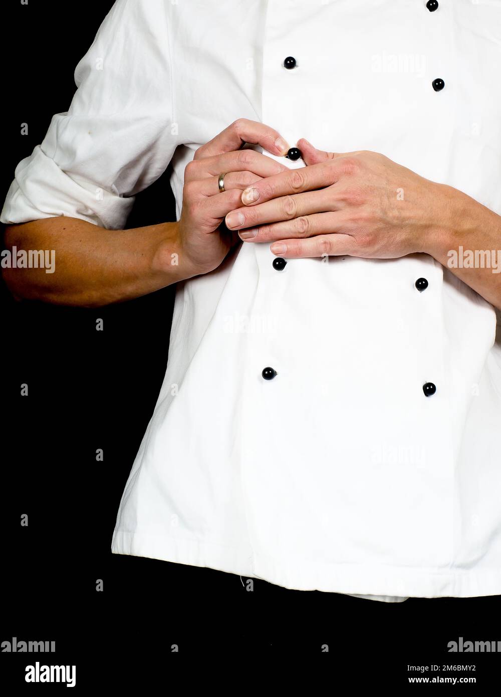 Professional chef buttoning up a white chefs jacket Stock Photo - Alamy