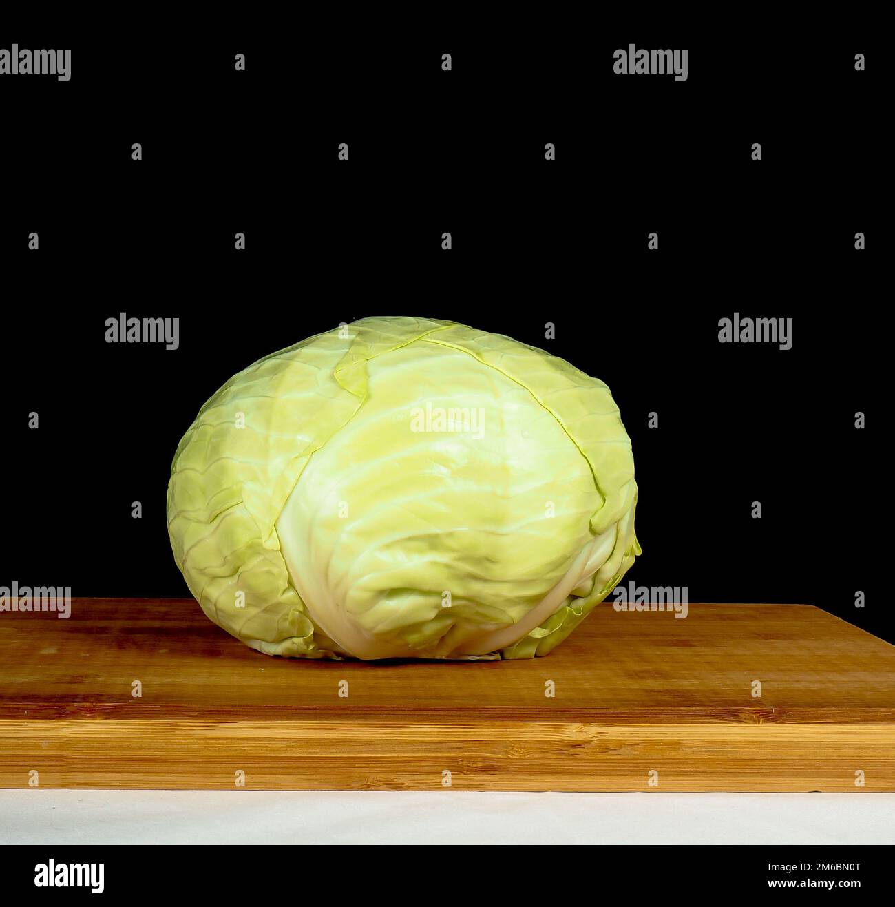 Whole cabbage isolated towards black Stock Photo - Alamy