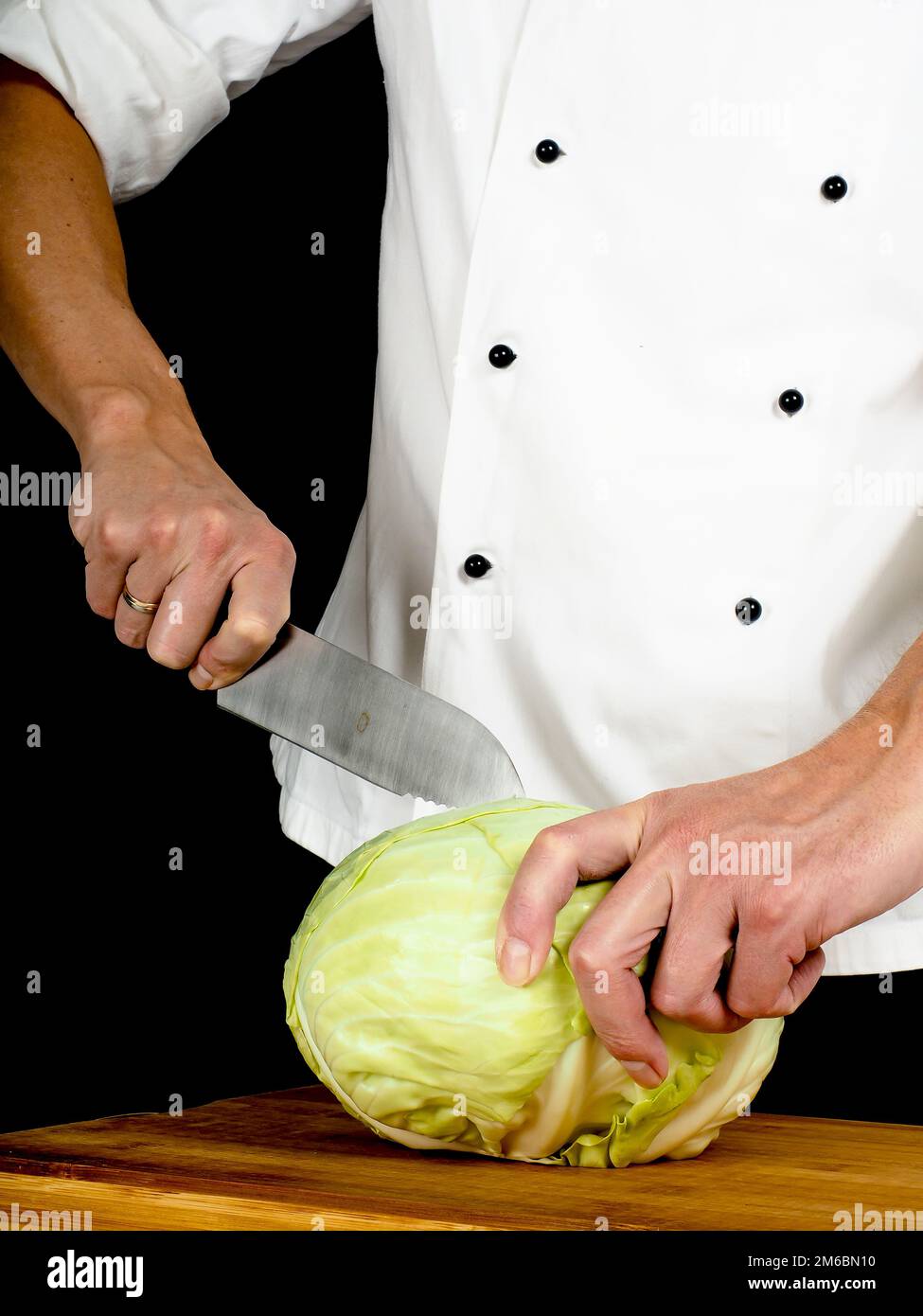 Professional chef holding a sharp cooking knife and cabbage Stock Photo ...