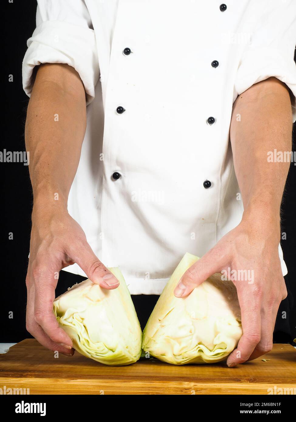Professional chef showing a cabbage cut into two Stock Photo - Alamy