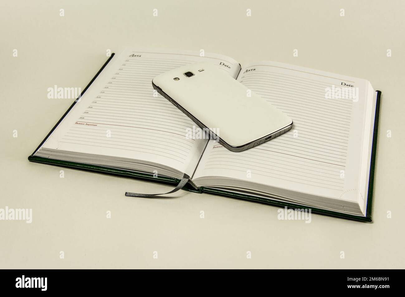Diary on a white background and a smartphone lying on it Stock Photo ...