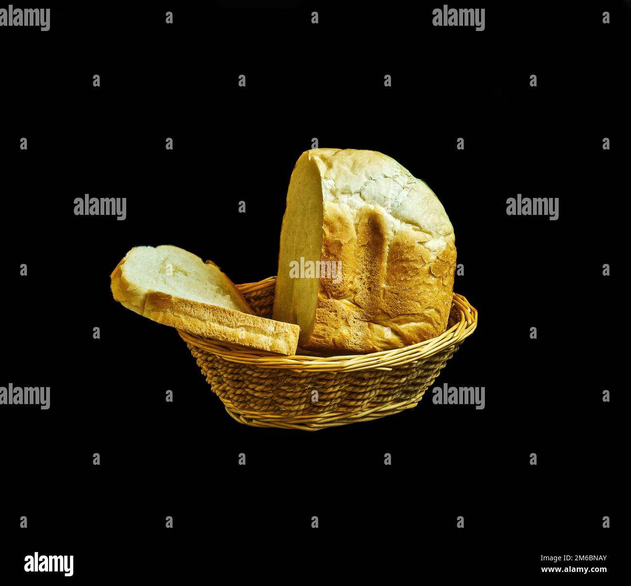 On a black background sliced white bread for sandwiches lies in the ...