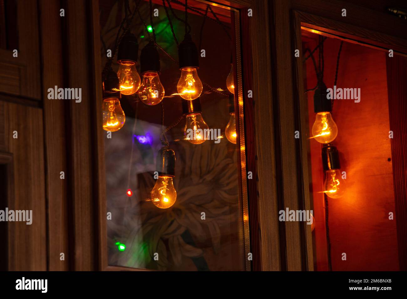 Christmas lights in the evening window of the house Stock Photo - Alamy