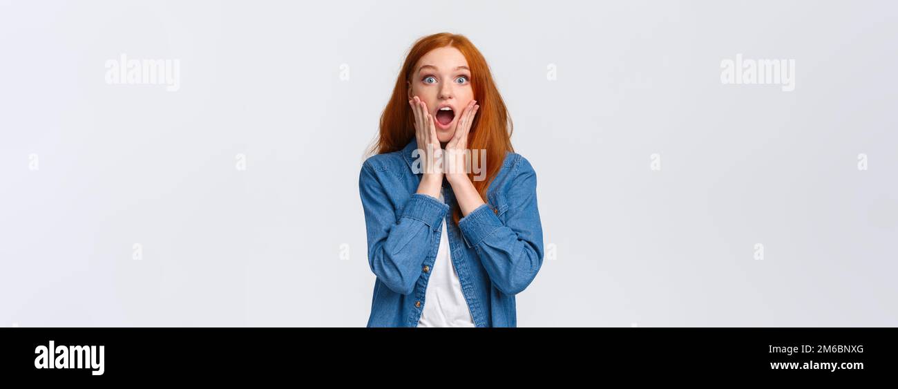 Oh my gosh, amazing. Surprised speechless redhead woman standing ...