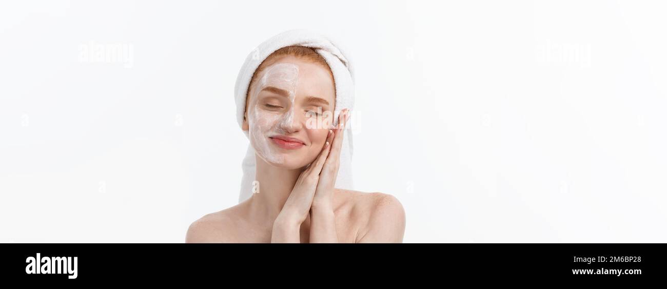 beautiful model applying cosmetic cream treatment on her face on white ...