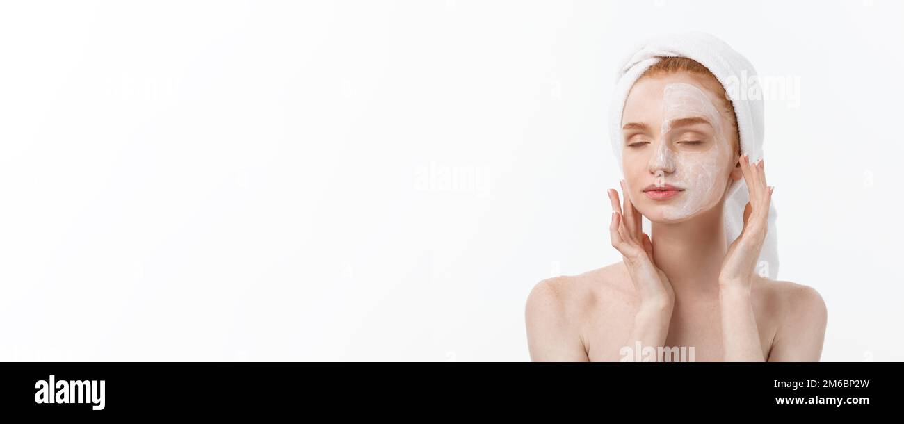 beautiful model applying cosmetic cream treatment on her face on white ...