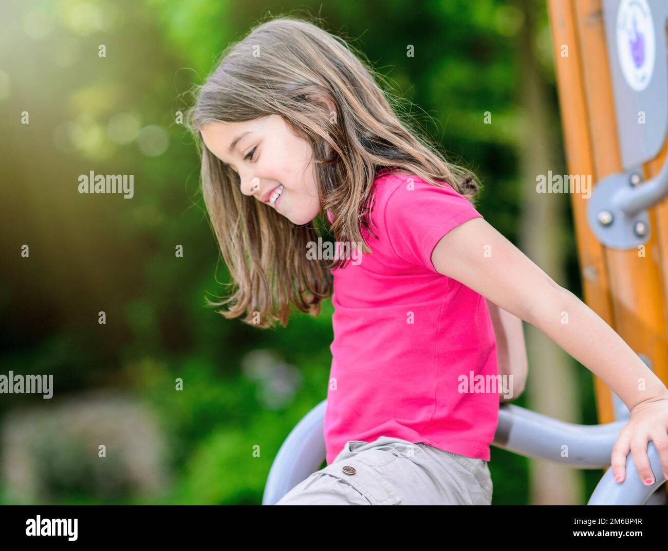 Pretty little girl on a playground Stock Photo - Alamy