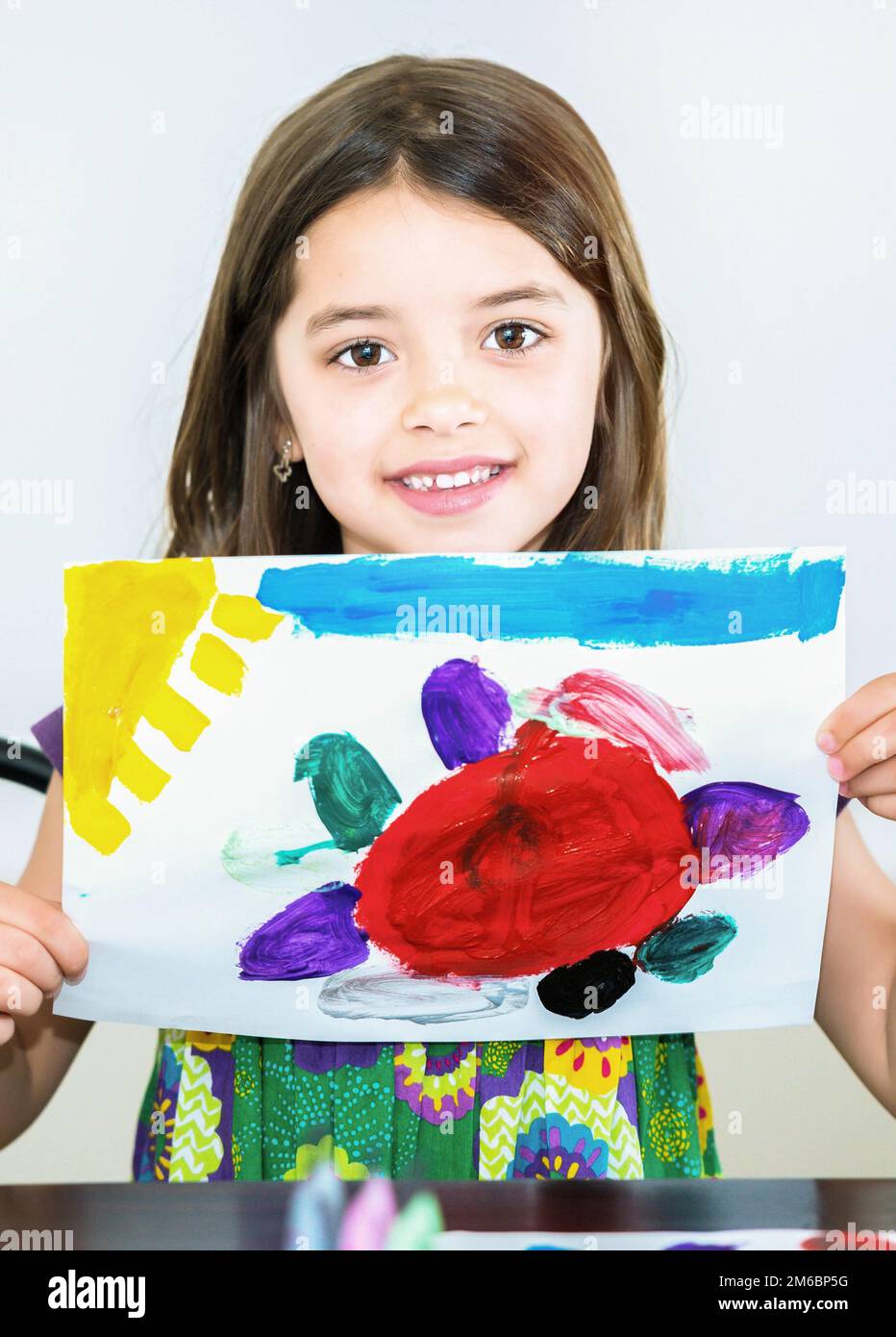 Portrait of a beautiful girl showing her drawing Stock Photo - Alamy