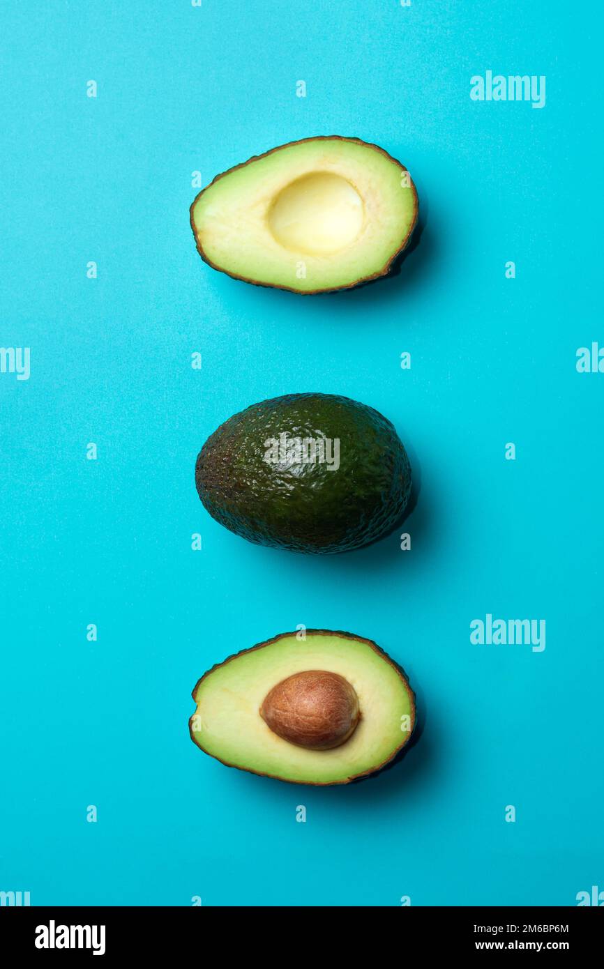 Fresh avocados on a blue background. Banner with free space for text ...