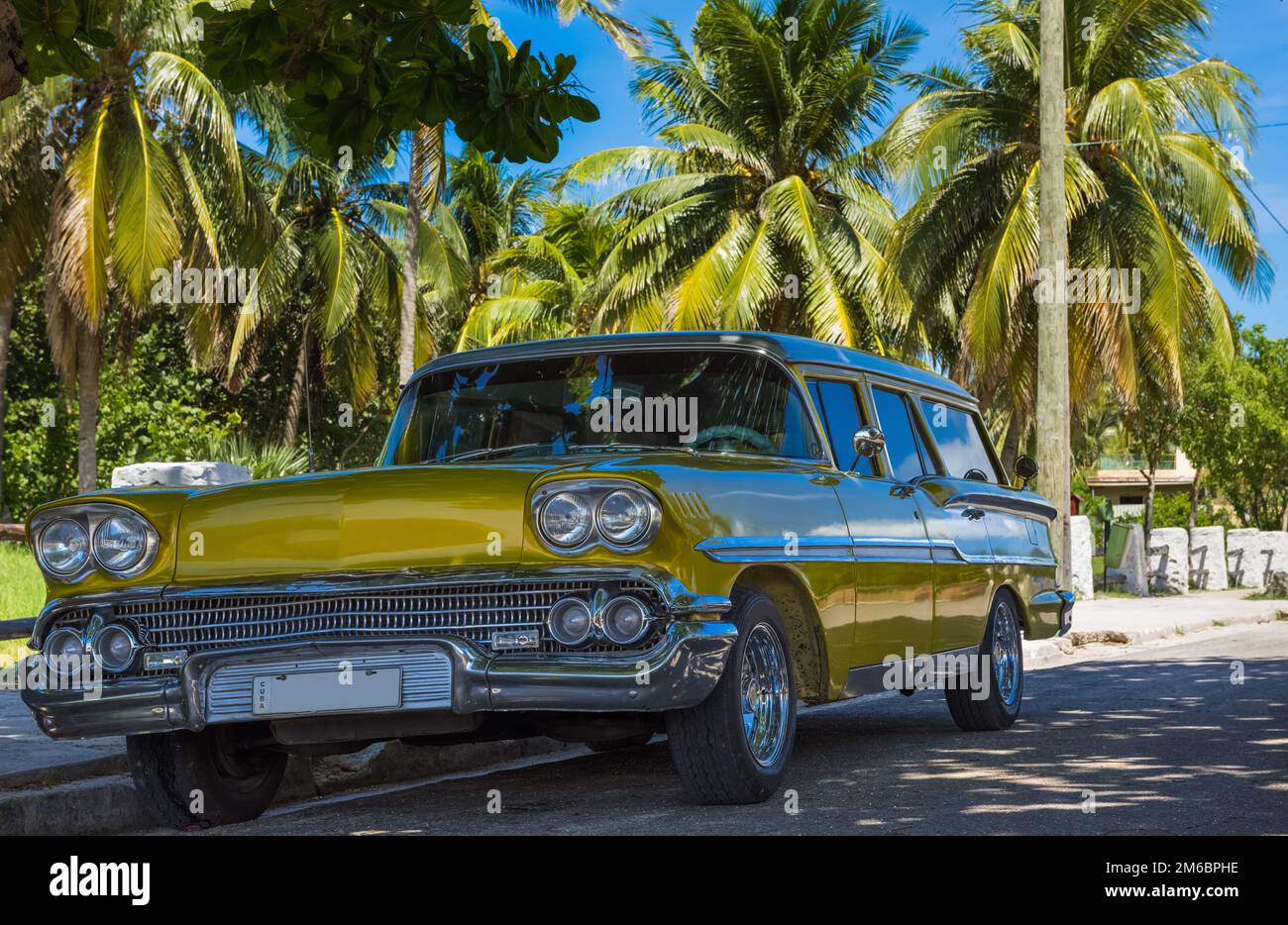 American gold-yellow vintage car park in Varadero near the beach in ...