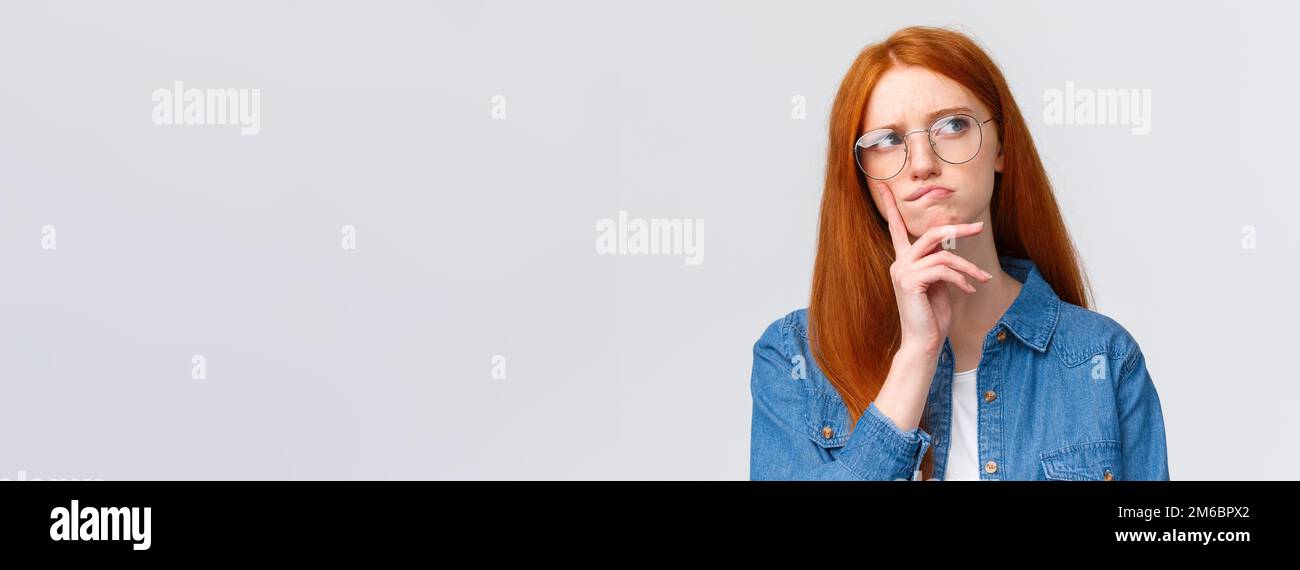 Close-up thoughtful and focused, creative female freelancer, student ...