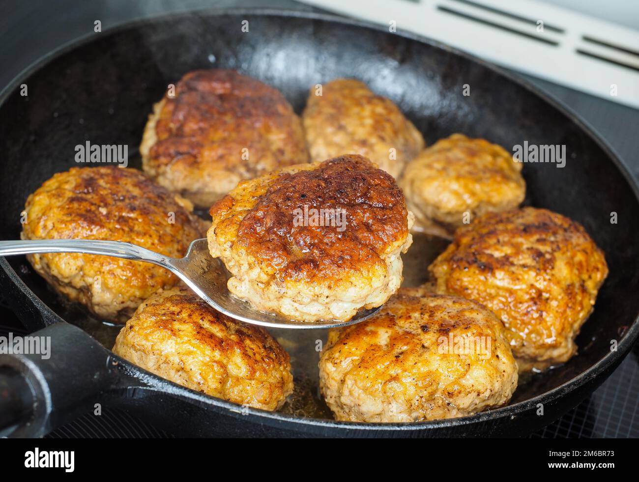 Frying homemade meatballs in black iron pan, in fine broth Stock Photo ...