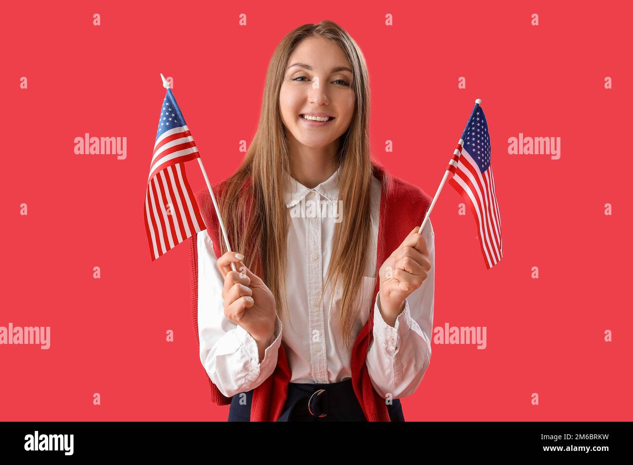 Beautiful woman with USA flags on red background Stock Photo - Alamy