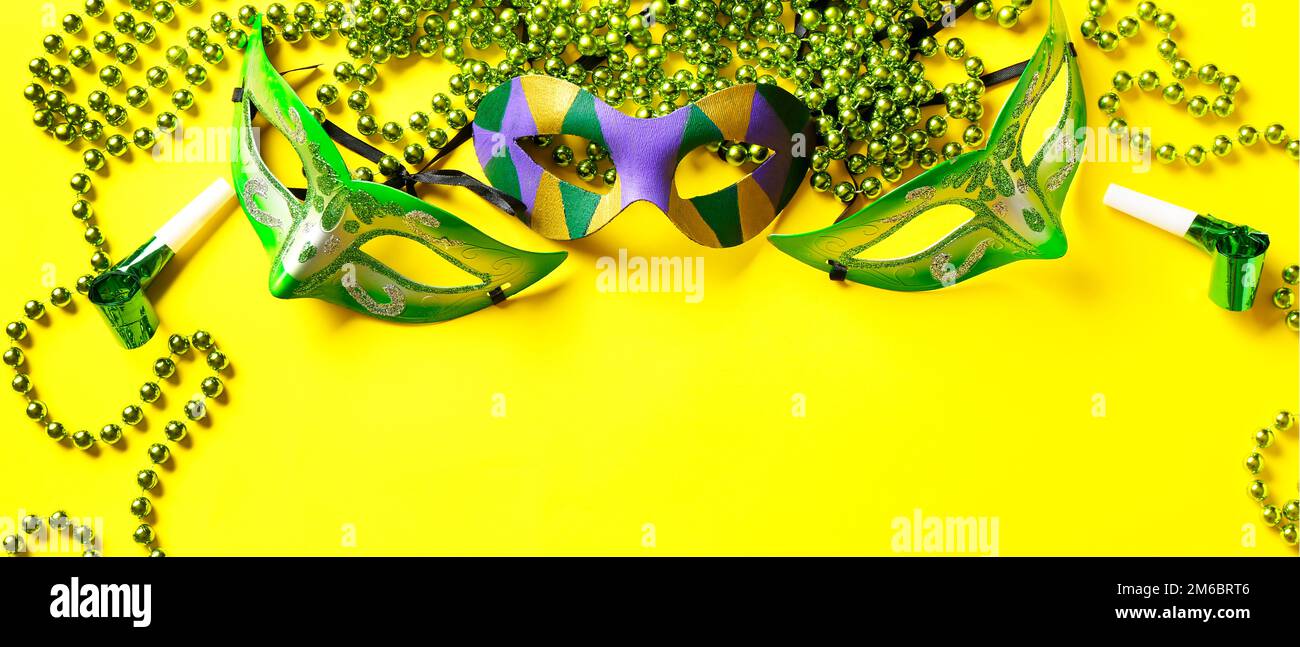 Carnival masks and decor on yellow background. Celebration of Mardi ...
