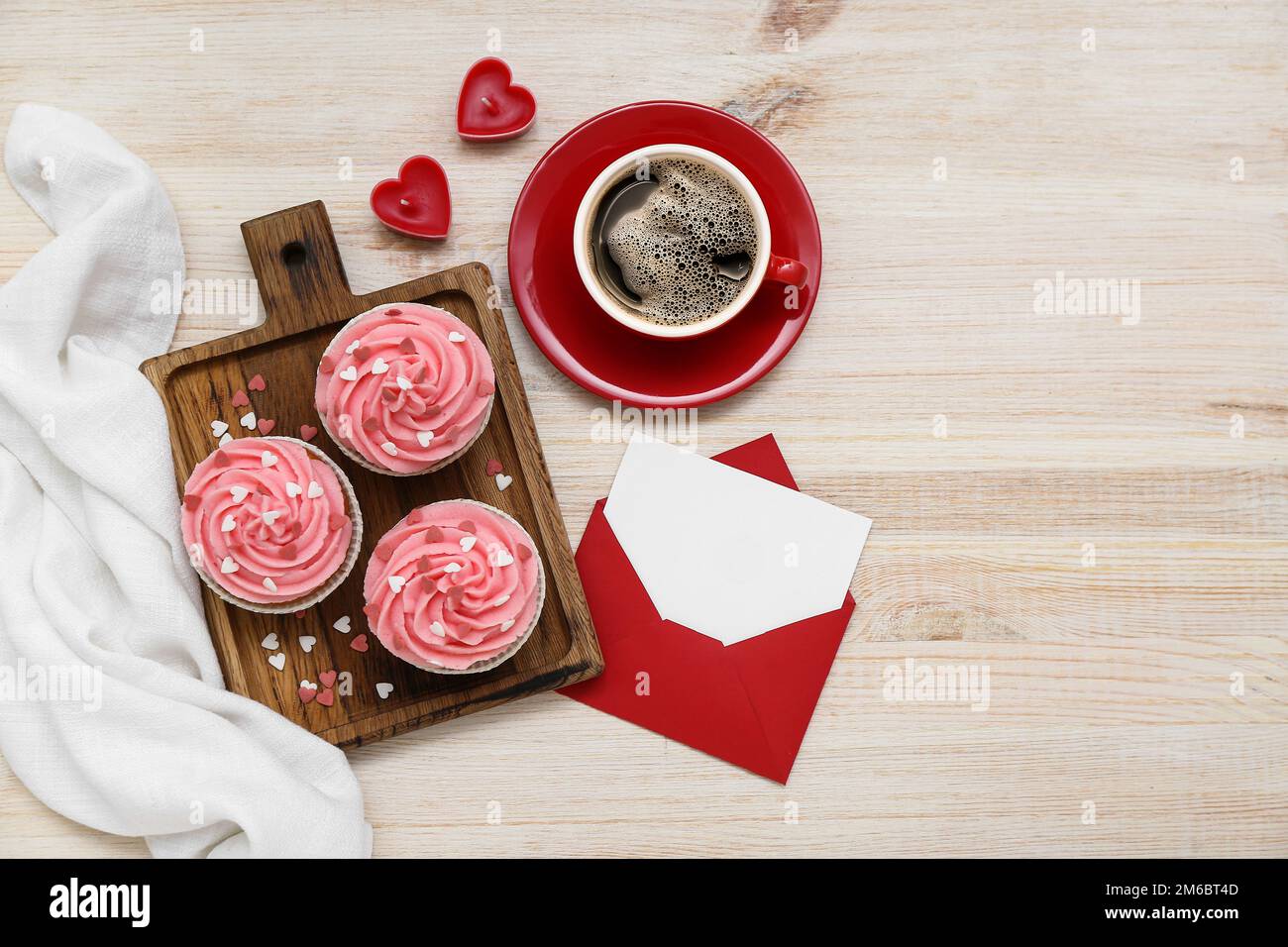 Board with cupcakes, cup of coffee and envelope for Valentine's Day on ...