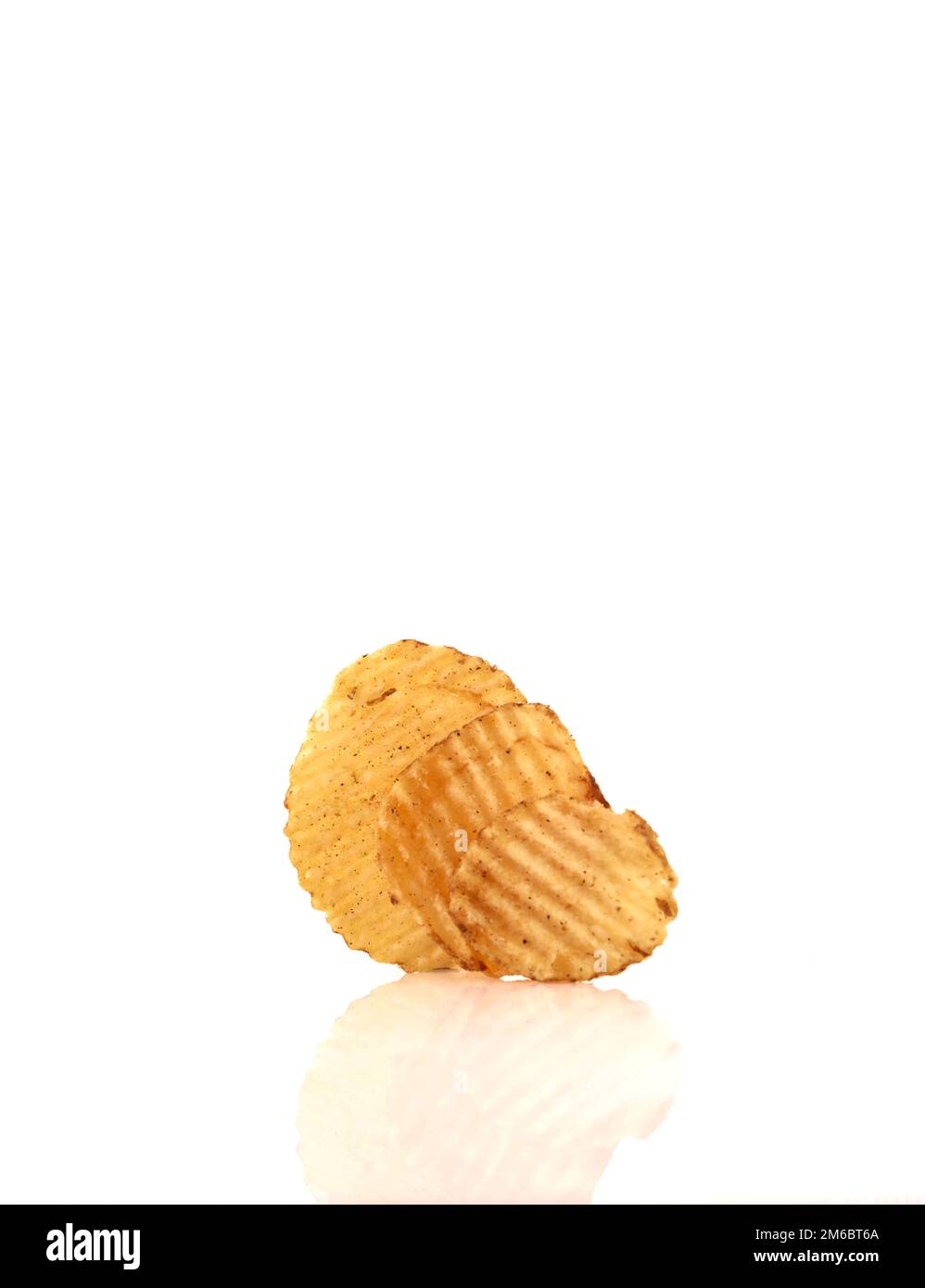 Food still life of potato crinkle cut crisps on plain background Stock ...