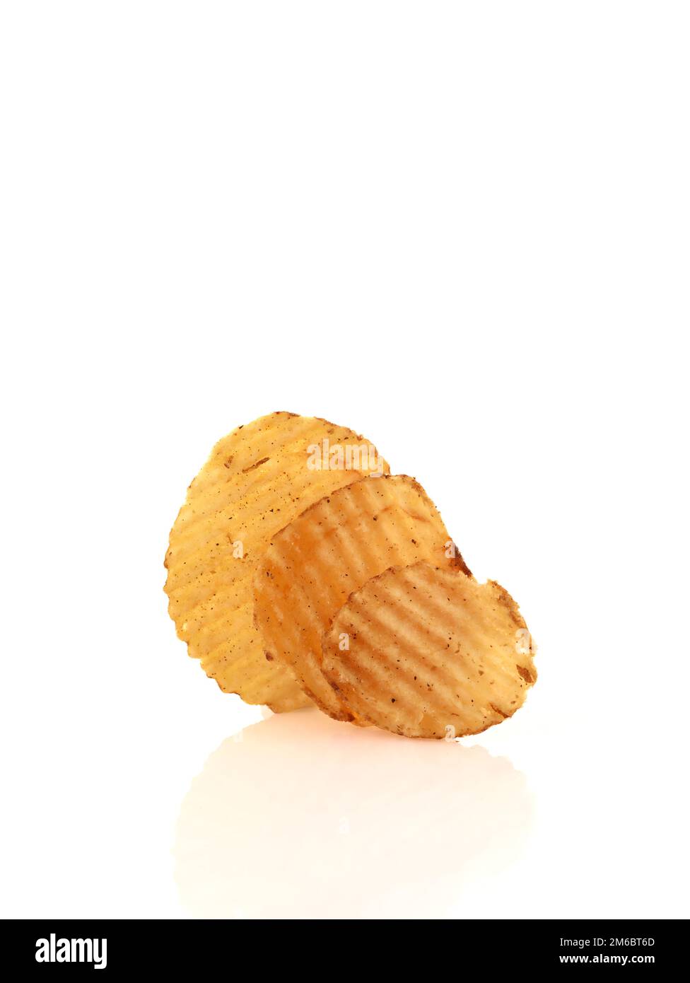 Food still life of potato crinkle cut crisps on plain background Stock ...