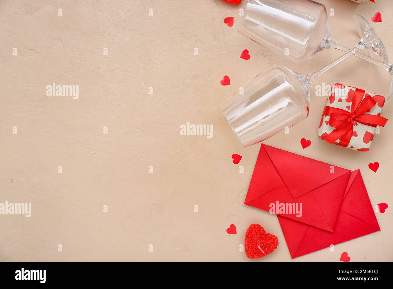 Glasses with envelopes, gift and hearts on beige background. Valentine ...